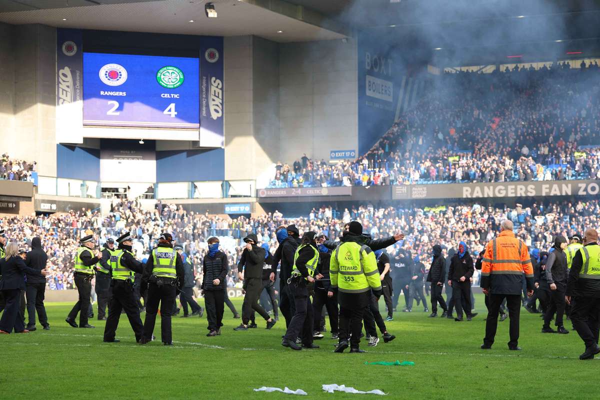 Nine fans arrested after on-pitch brawl in clash between Rangers and ...